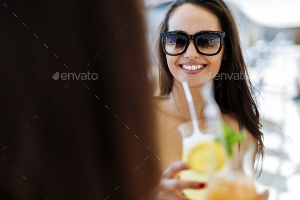 Beautiful young women drinking cocktails Stock Photo by nd3000 | PhotoDune