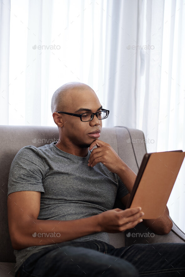 Reading young Black man Stock Photo by DragonImages | PhotoDune