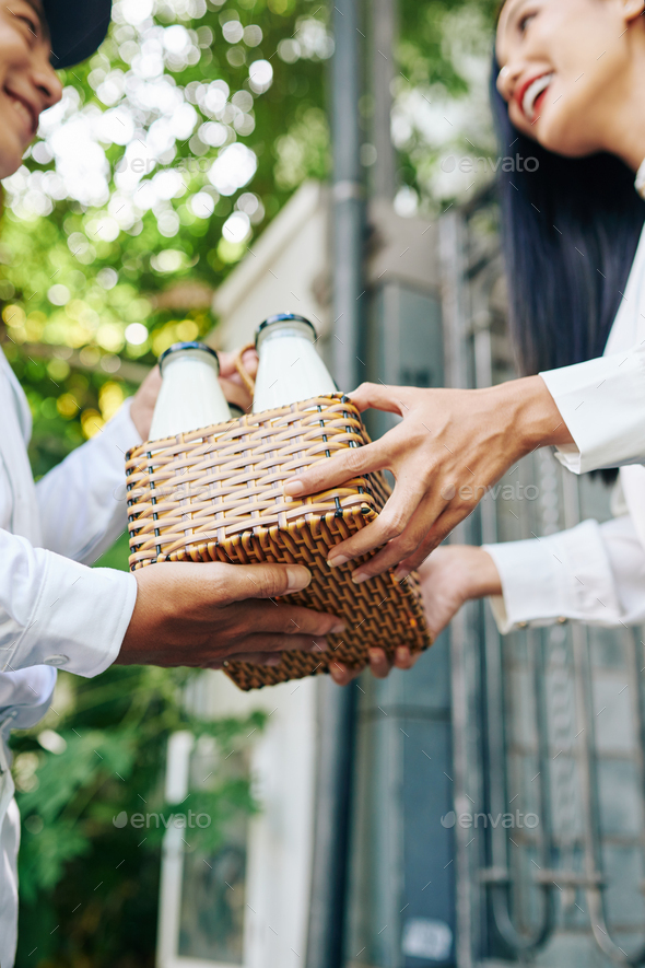 Customer receiving fresh milk Stock Photo by DragonImages | PhotoDune