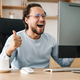 Image of programmer man showing thumb up while working with computer ...