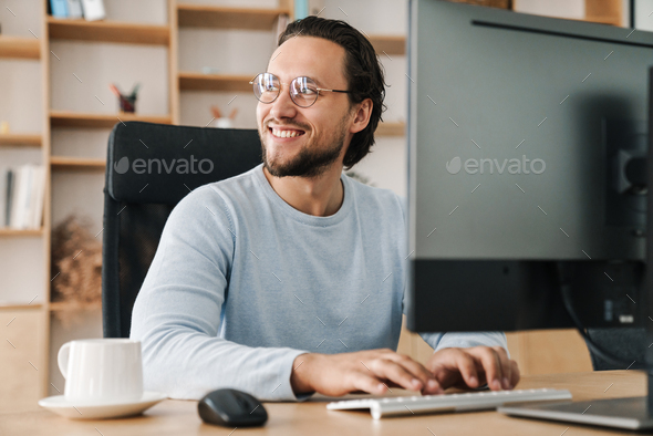 Image of smiling unshaven programmer man working with computer Stock ...