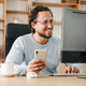 Image of programmer man using cellphone while working with computer ...