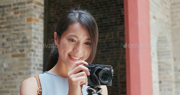 Smiling woman taking video with her camera at outdoor Stock Photo by ...