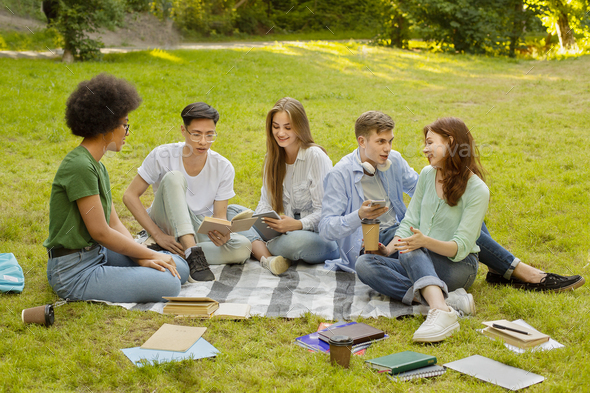 Free Time In Campus. Group Of College Students Relaxing On Lawn ...