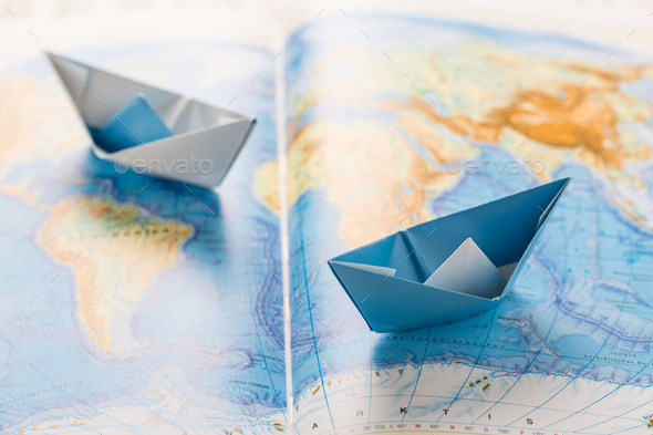 Paper boats on world map. Concept of traveling or military exercise ...