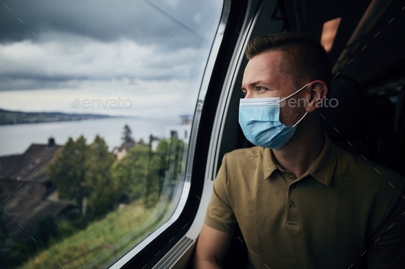 Man wearing face mask inside train Stock Photo by Chalabala | PhotoDune