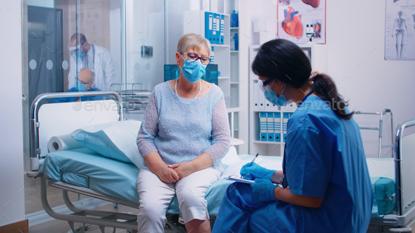 Nurse questioning senior patient Stock Photo by DC_Studio | PhotoDune