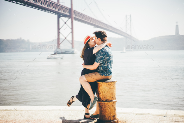 Romantic couple kissing in front of the bridge called April 25 in ...
