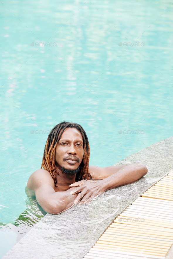 Black man in swimming pool Stock Photo by DragonImages | PhotoDune