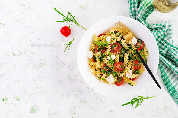 Fusilli Pasta - Caprese salad with tomato, mozzarella and basil. Stock ...
