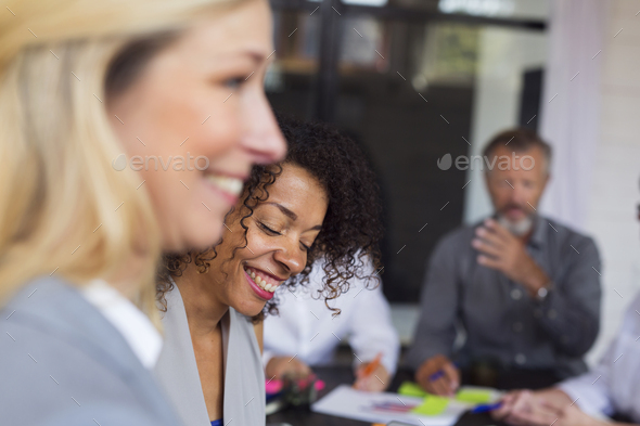 Business people laughing in office during meeting Stock Photo by ...