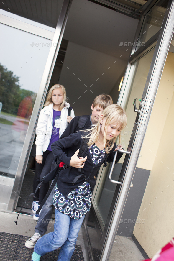 Junior high students leaving school Stock Photo by astrakanimages ...