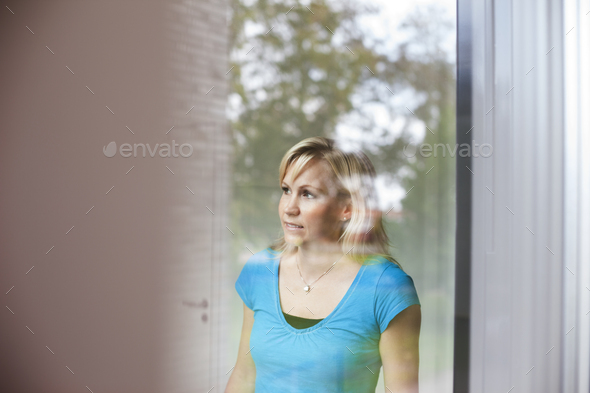 Thoughtful beautiful woman seen through window Stock Photo by ...