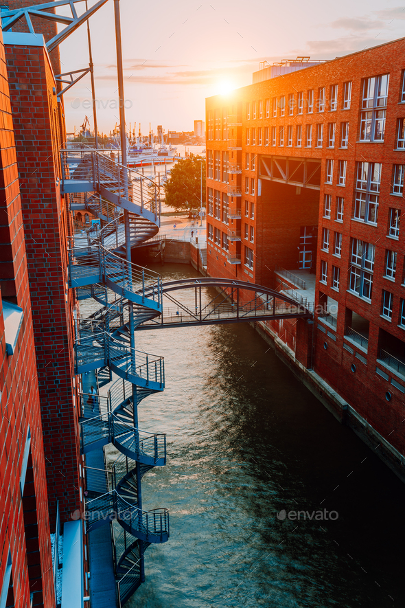Circular staircase, bridge over canal and red brick buildings in the ...