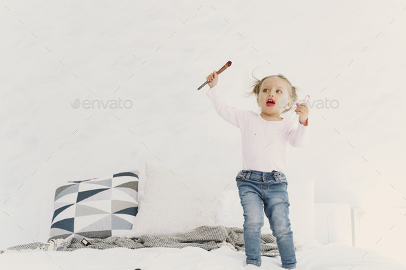 Pretty little girl with makeup cosmetics at home Stock Photo by prostooleh