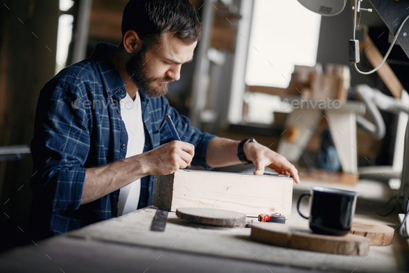 Man in the workshop with a wood Stock Photo by prostooleh | PhotoDune
