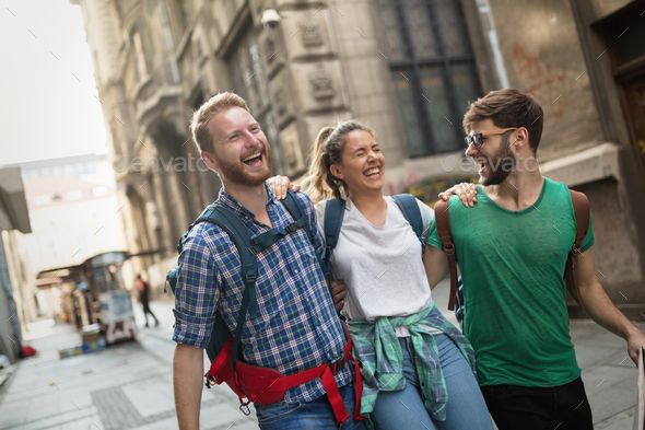 Happy group of tourists traveling and sightseeing Stock Photo by nd3000