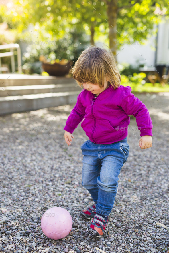 Little girl playing football Stock Photo by astrakanimages | PhotoDune