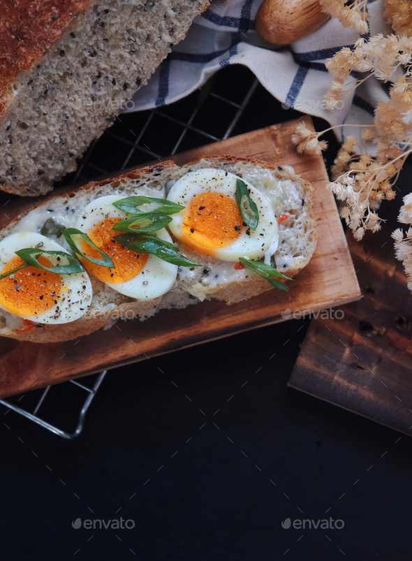 Open faced sandwich sourdough bread with sliced egg yolk Stock Photo by ...