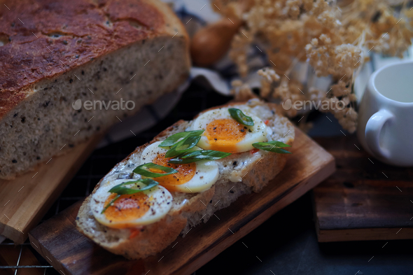Open faced sandwich sourdough bread with sliced egg yolk Stock Photo by ...