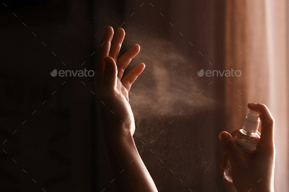 Disinfecting hands. Person using antiseptic spray on hands Stock Photo ...