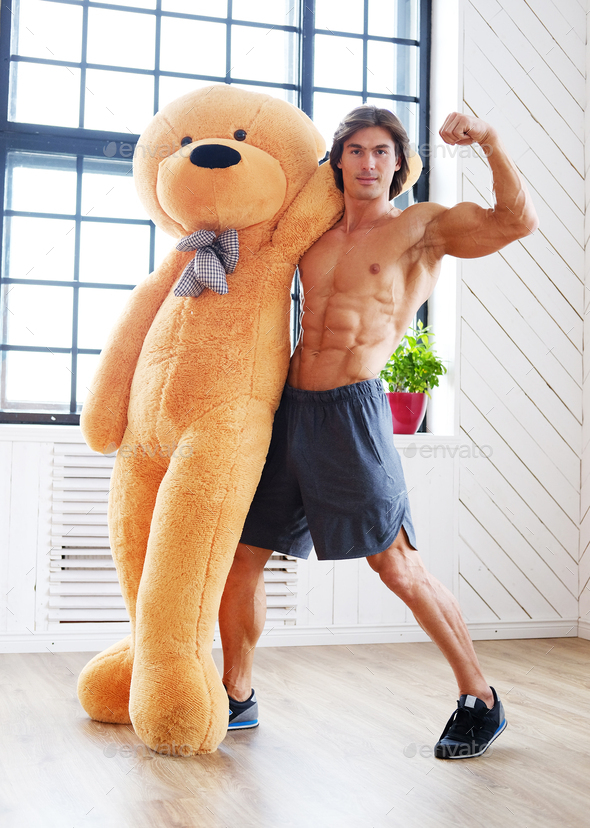 Male posing with big red teddy bear. Stock Photo by fxquadro | PhotoDune