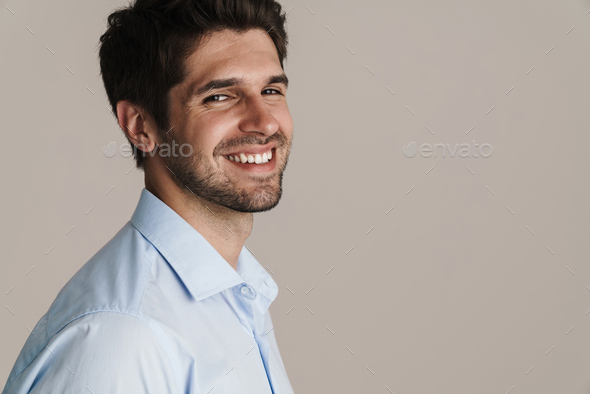 Image of smiling man looking at you isolated by beige background Stock ...
