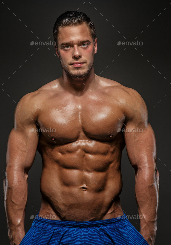 Attractive muscular guy in studio Stock Photo by fxquadro | PhotoDune