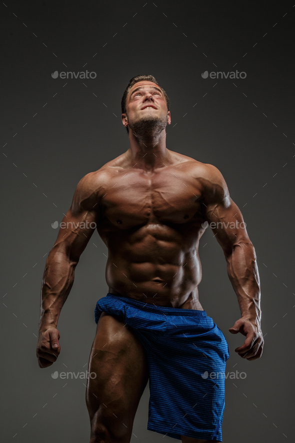 Muscular guy posing in studio Stock Photo by fxquadro | PhotoDune