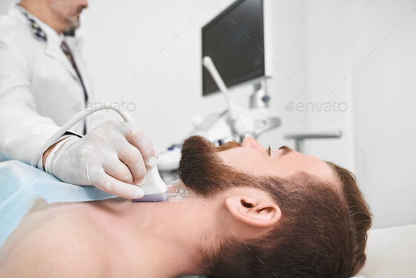 Doctor using ultrasound probe for lymph node diagnosis Stock Photo by ...