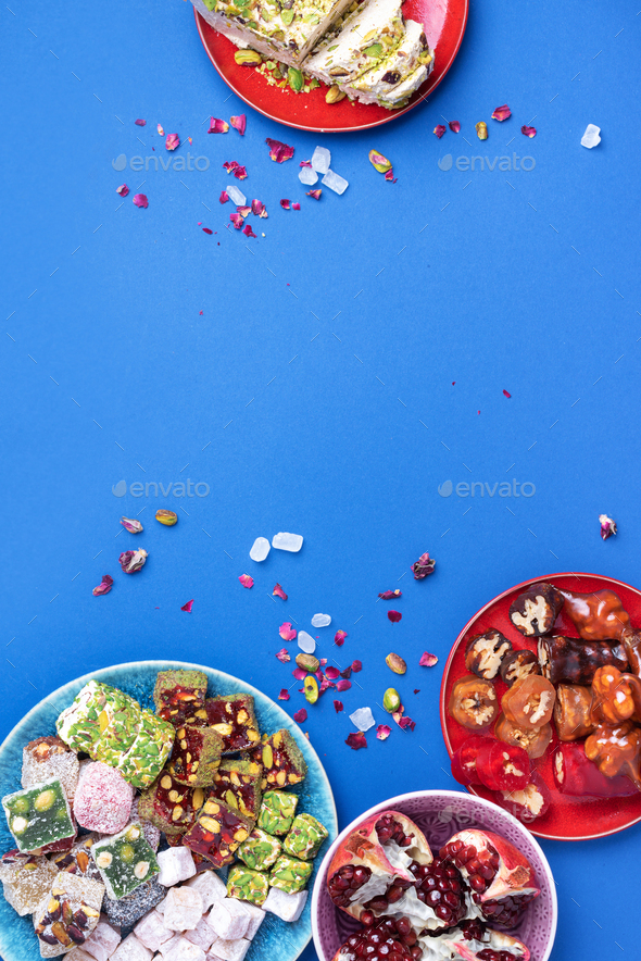 Middle Eastern sweets on blue background. Arab dessert, baklava, halva ...