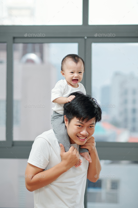 Happy father carrying daughter Stock Photo by DragonImages | PhotoDune