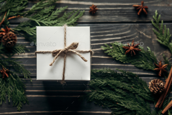 Simple present box and thread on wooden background Stock Photo by Sonyachny