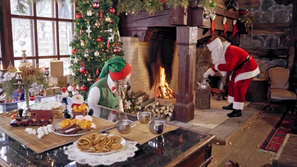 Santa Claus and an elve girl. Santa preparing tea. Santa Claus with ...