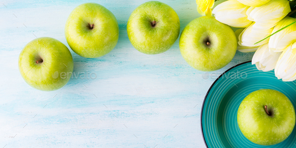 Green pastel background with apples. Healthy food Stock Photo by tenkende