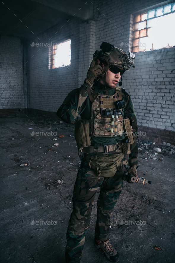 Military men with arms defending the building. Soldier stand guard ...