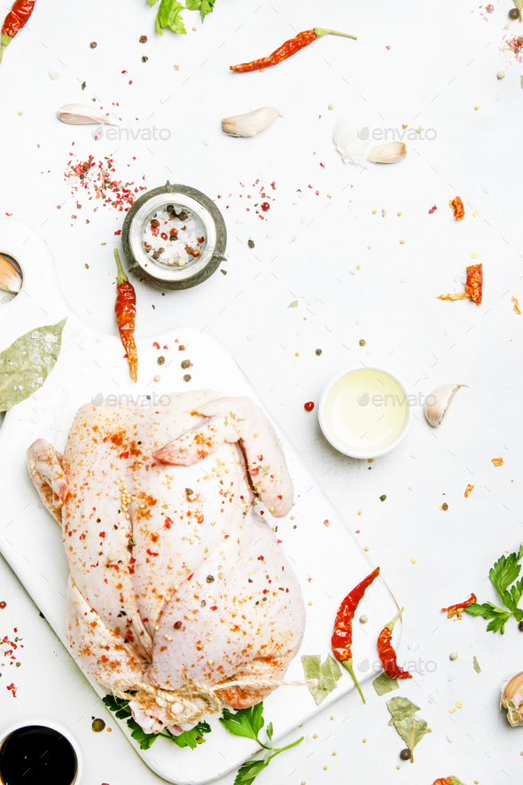 Raw whole chicken with spices and marinade, gray background, top view ...