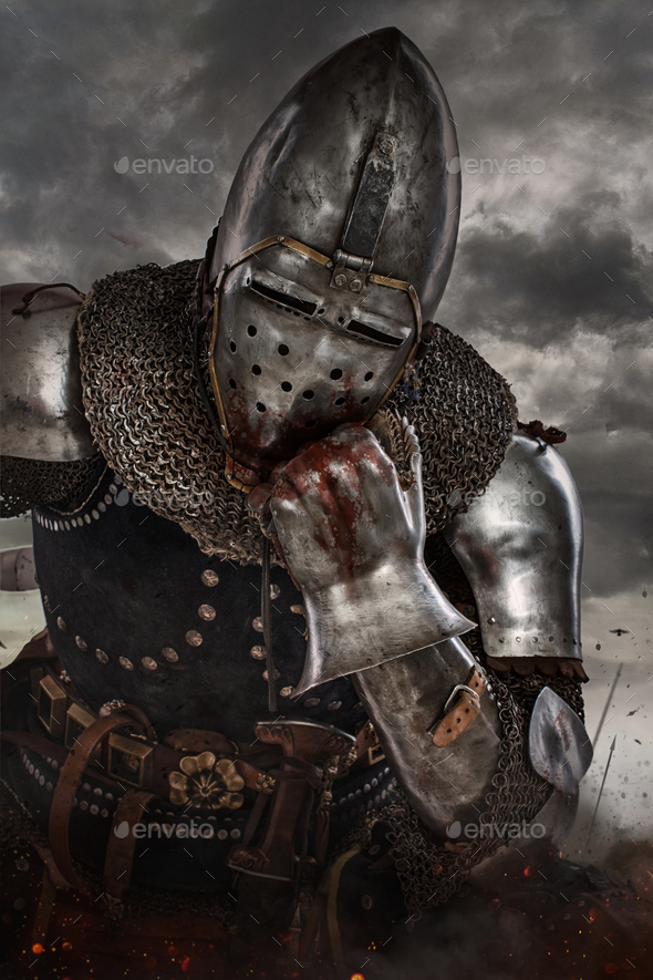 Thoughtful knight over dark clouds background. Stock Photo by fxquadro
