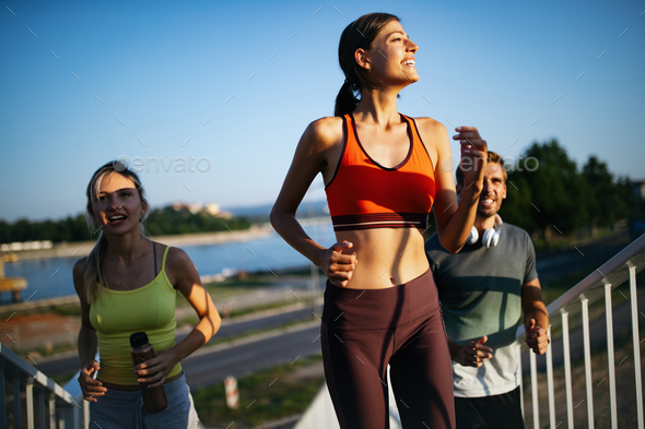 Fit happy friends jogging and running together outdoor in city Stock ...