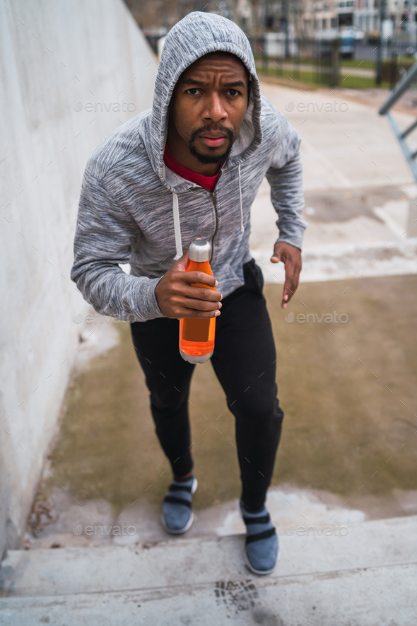 Sport man running up on stairs. Stock Photo by megostudio | PhotoDune