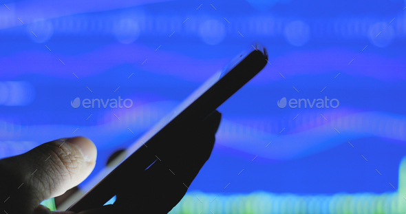 Checking mobile phone message with stock market background Stock Photo ...