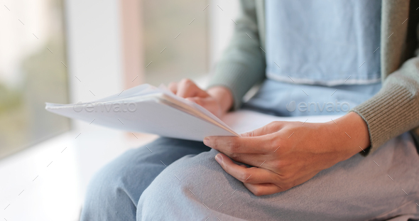 Student reading note on paper at school Stock Photo by leungchopan