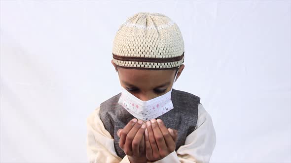 A Muslim child wearing a mask praying to Allah, God 4k footage, Stock ...