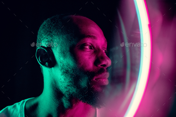 Cinematic portrait of handsome young man in neon lighted room, stylish ...