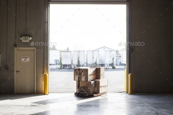 Products in boxes at a loading dock door in a distribution warehouse ...