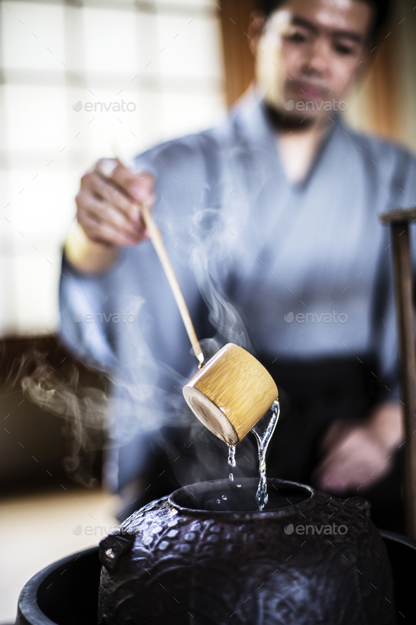 Traditional Japanese Tea Ceremony, man using a Hishaku, a bamboo ladle ...