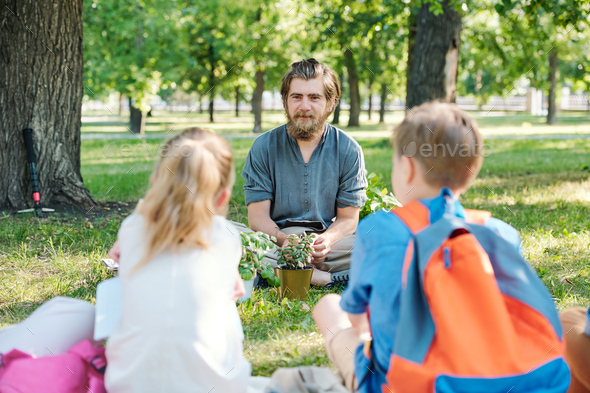 Botany teacher working with schoolchildren Stock Photo by Pressmaster