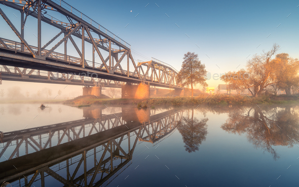 Beautiful railroad bridge and river in fog at sunrise in autumn Stock ...