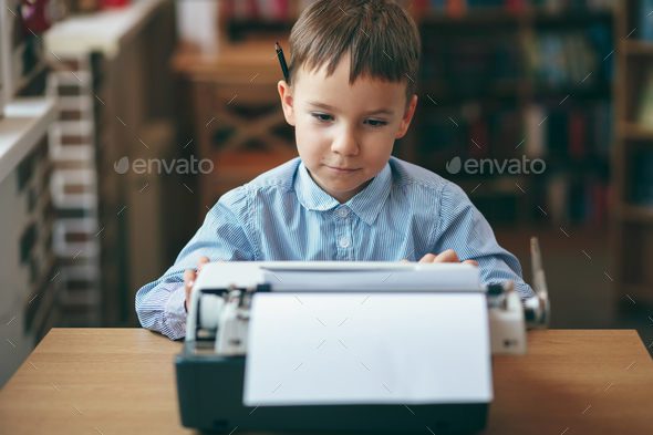 Boy with typewriter Stock Photo by diignat | PhotoDune