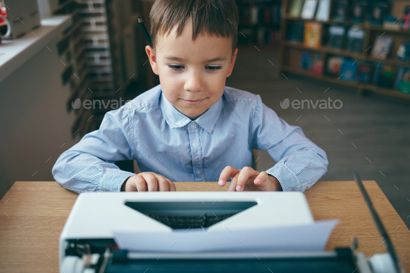 Boy with typewriter Stock Photo by diignat | PhotoDune